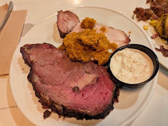 The prime rib arrives like a carnivore's dream – perfectly pink, seasoned edge, with sides playing supporting roles they've clearly rehearsed for years.