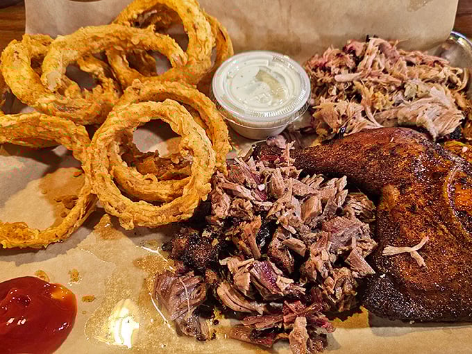 Behold the holy trinity: pulled pork, crispy chicken, and those golden onion rings. A paper-lined tray never held such glorious treasures.