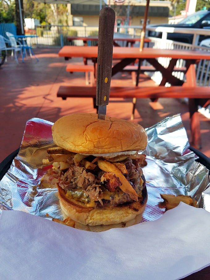 Behold the architectural marvel that is Uncle Chicken's pulled pork sandwich—where smoke meets sweet in a handheld masterpiece that demands a knife for support.