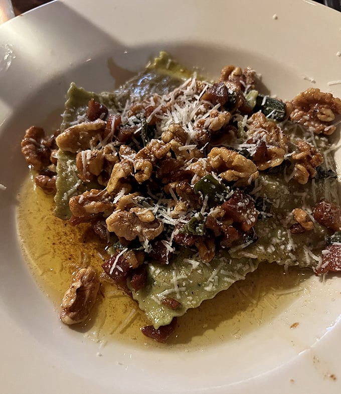 Behold the pumpkin ravioli: autumn's answer to edible poetry, crowned with walnuts and sage like nature's tiara.