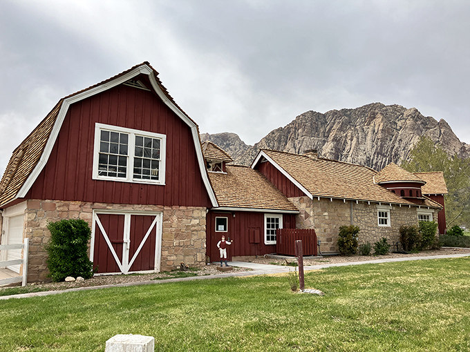 This isn't just a barn; it's a time machine with windows. The red structure stands proudly against mountains that have watched centuries unfold.