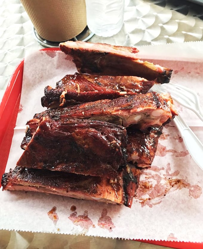 These ribs don't just fall off the bone—they practically leap into your mouth with smoky enthusiasm.