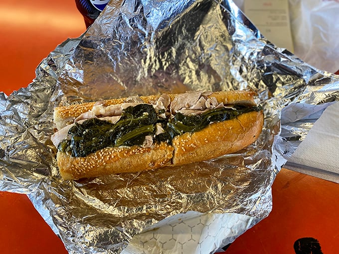 This isn't just a roast pork sandwich—it's a masterclass in balance, where tender meat meets bitter greens in a harmony that makes taste buds applaud.
