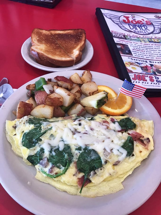 This isn't just an omelet—it's a love letter to breakfast. Spinach and cheese embrace like old friends while those home fries deserve their own fan club.