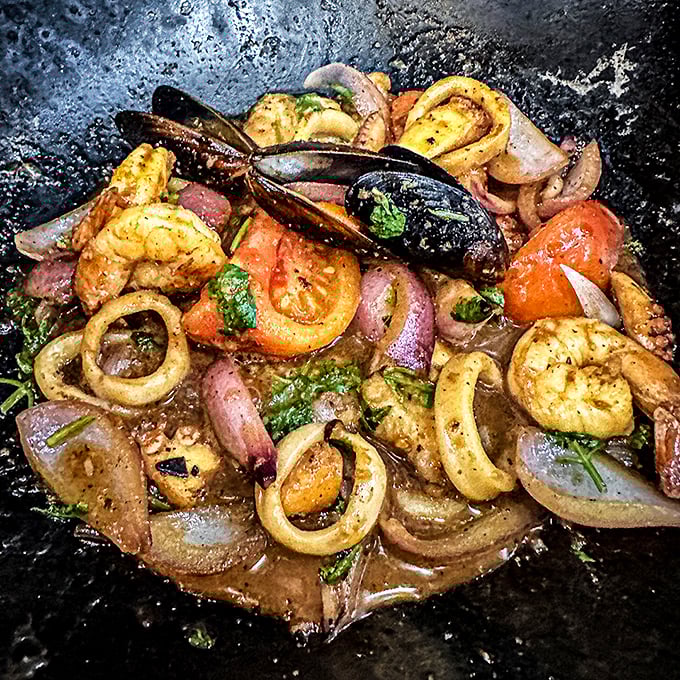 A symphony of seafood in one sizzling pan—shrimp, calamari, and mussels performing a delicious dance in savory broth.
