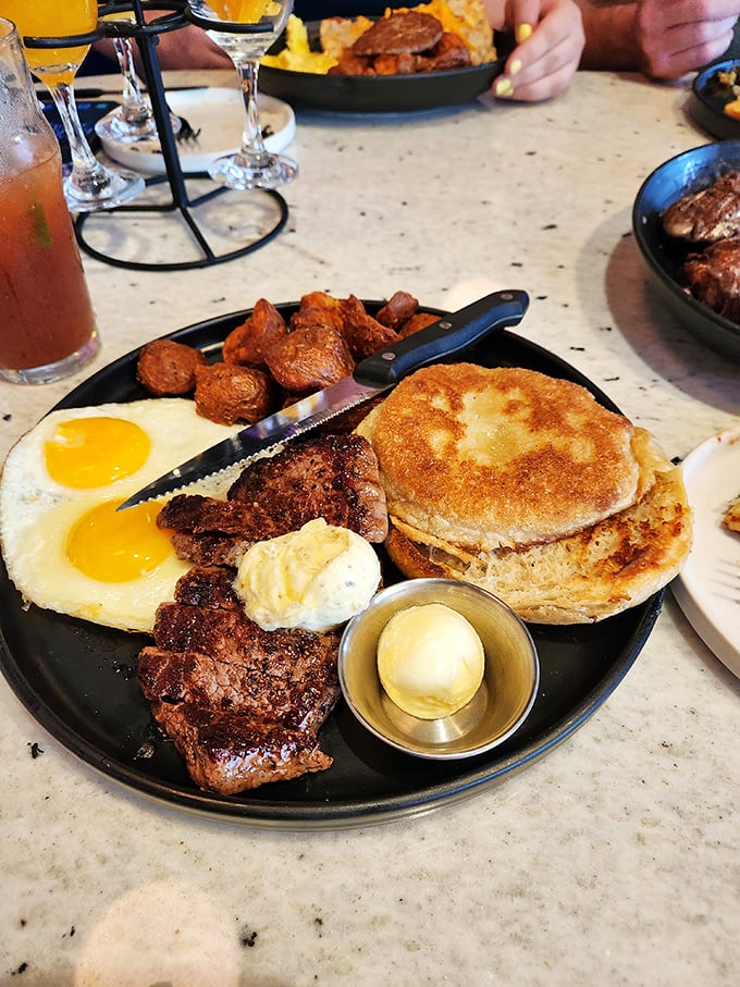This breakfast plate isn't just a meal—it's morning architecture: perfectly cooked eggs, seasoned steak, and those legendary home fries forming the foundation.