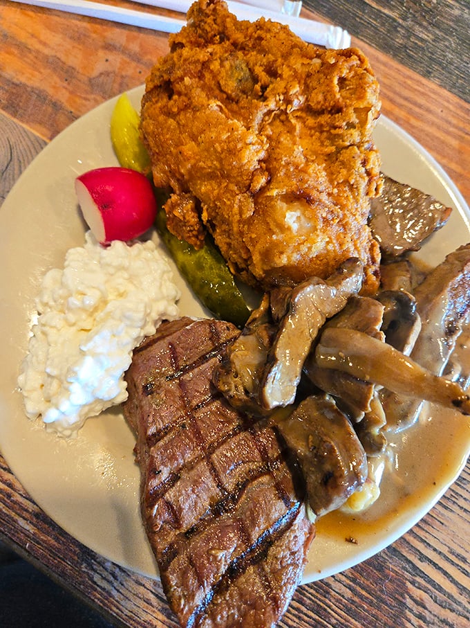 A plate that tells a story of indulgence—perfectly grilled steak, crispy fried chicken, and mushroom gravy that would make your grandmother nod in approval.