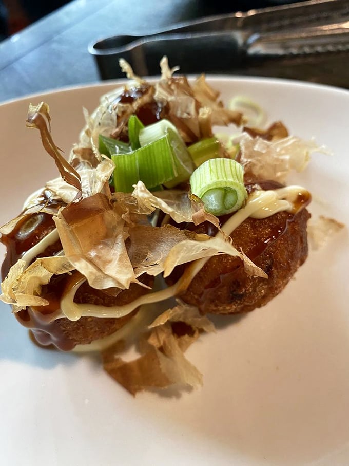 Takoyaki that's dressed to impress—crispy octopus balls topped with dancing bonito flakes that wave hello as you devour them.