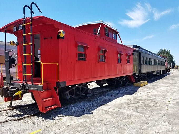 The classic red caboose, complete with its observation cupola and sturdy yellow ladder, stands as a cheerful reminder of railroading's more colorful past.