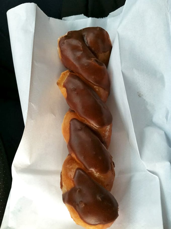 The chocolate-glazed twist might be the most elegant dance partner your coffee has ever had—a perfect spiral of sweet satisfaction.
