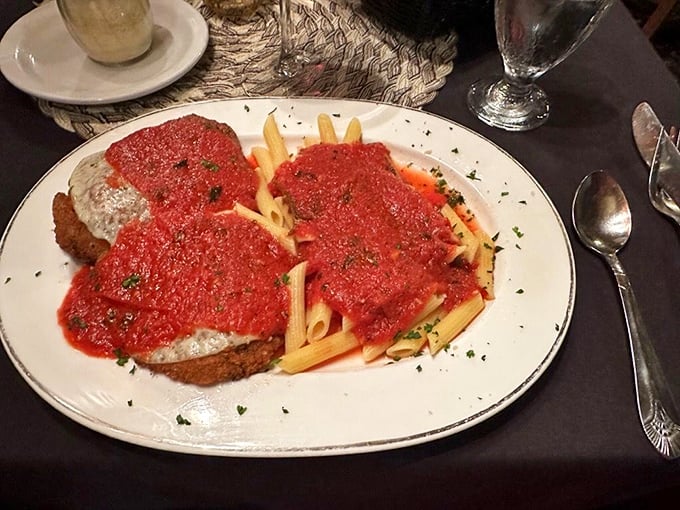 Veal parmigiana that doesn't know the meaning of restraint—tender cutlets swimming in marinara with penne pasta playing the perfect supporting role.