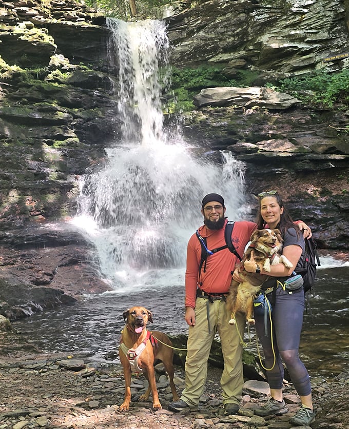 Adventure is better when shared—especially with four-legged hiking buddies. These waterfall explorers found the perfect backdrop for their family portrait.