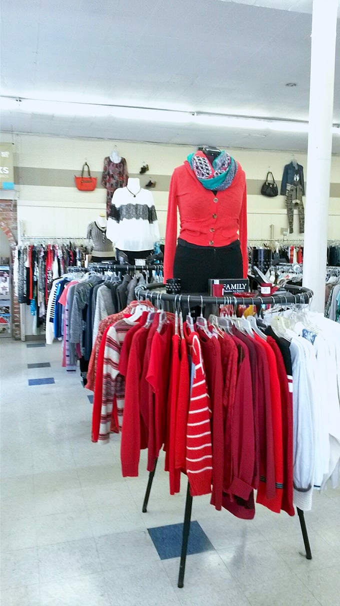 A splash of red brightens the women's clothing section, where winter sweaters and cardigans await their next adventure in someone's wardrobe.