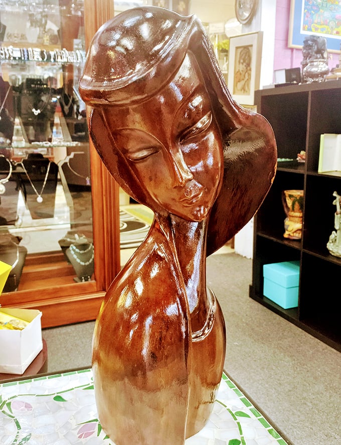 This elegant wood carving seems to be contemplating life's mysteries—or perhaps just judging your shopping choices with serene dignity.