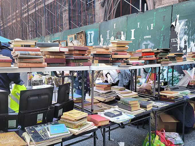 Stacks of vintage books tower like literary skyscrapers, each spine holding stories waiting for new readers to discover.