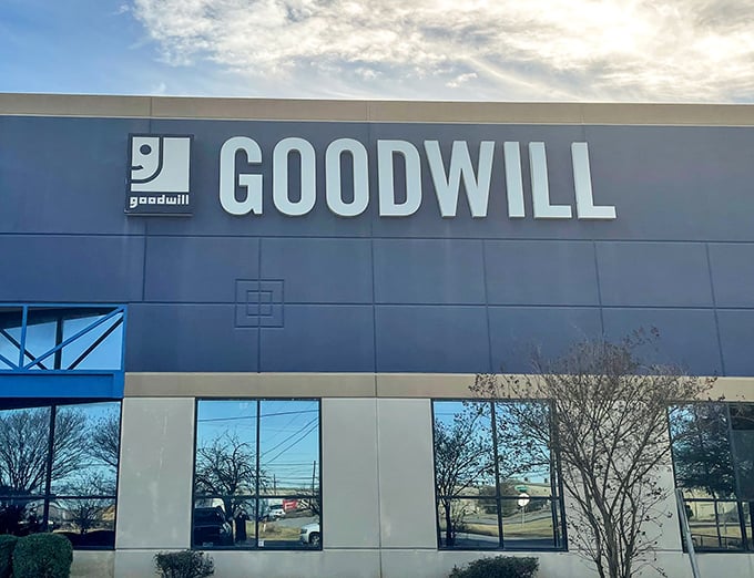 That sleek Goodwill facade hints at the organized outlet shopping experience waiting inside those doors.