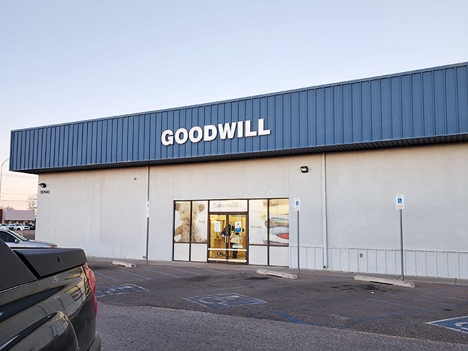 Goodwill's blue sign beckons like a lighthouse for bargain hunters navigating the sea of retail markup. The treasures inside won't disappoint.