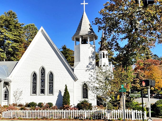 That pristine white steeple reaches toward heaven like a postcard from simpler, more graceful times.