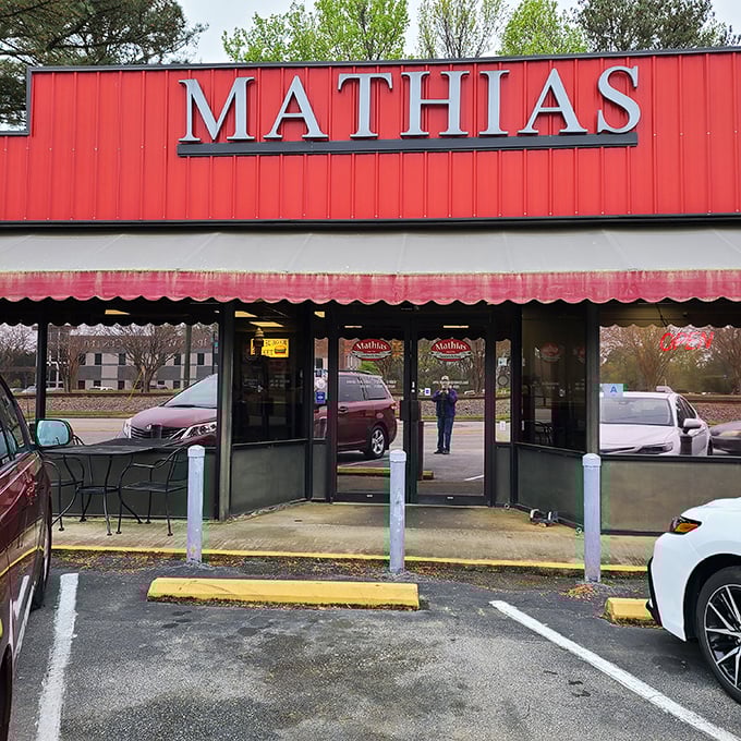 Mathias' bold red sign calls to hungry travelers like a beacon of sandwich salvation.