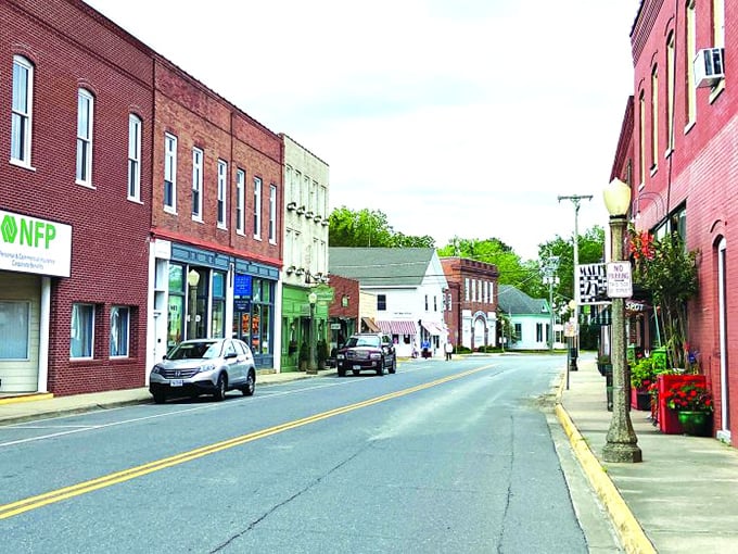 Red brick buildings stand shoulder-to-shoulder like old friends sharing decades of small-town secrets and stories.