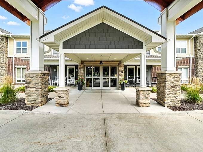 Stone and timber craftsmanship creates an entrance that's more mountain retreat than typical retirement community.