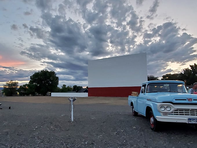 As twilight settles over Montrose, the Star Drive-In’s screen stands ready for showtime, with a vintage blue truck adding a touch of nostalgia to the scene.