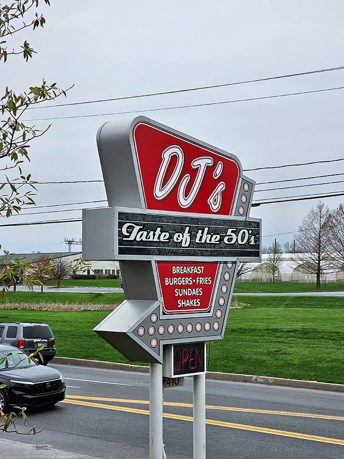 That retro sign at DJ's isn't just advertising breakfast and burgers—it's promising a trip back to simpler times when milkshakes came in metal mixing cups.