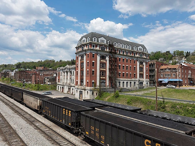CSX coal cars deliver their black gold beneath Grafton's brick sentinel, a building that's seen more history than Ken Burns documentaries.