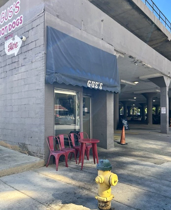 Those bright red chairs outside Gus's aren't just seating—they're front-row tickets to Birmingham's hot dog theater.