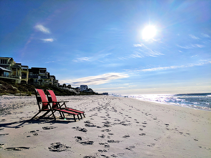 Red beach chairs standing sentinel on Inlet Beach – waiting for you to claim your throne overlooking the emerald kingdom.