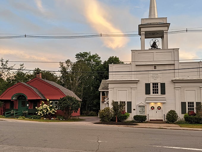 Evening light falls softly over Jackson’s heart — where community, history, and small-town warmth meet beneath the bell tower and beside the red cottage.