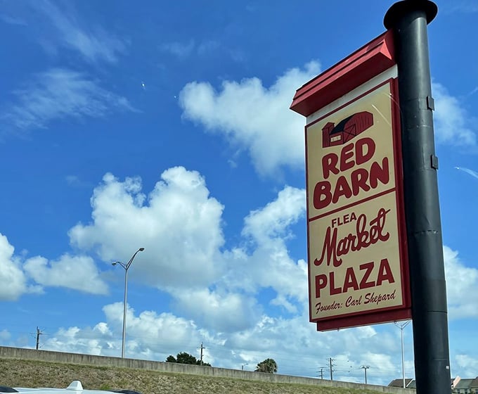 That bright red sign sets the tone — under the open sky, the market hums with energy and nonstop bargains, rain or shine.