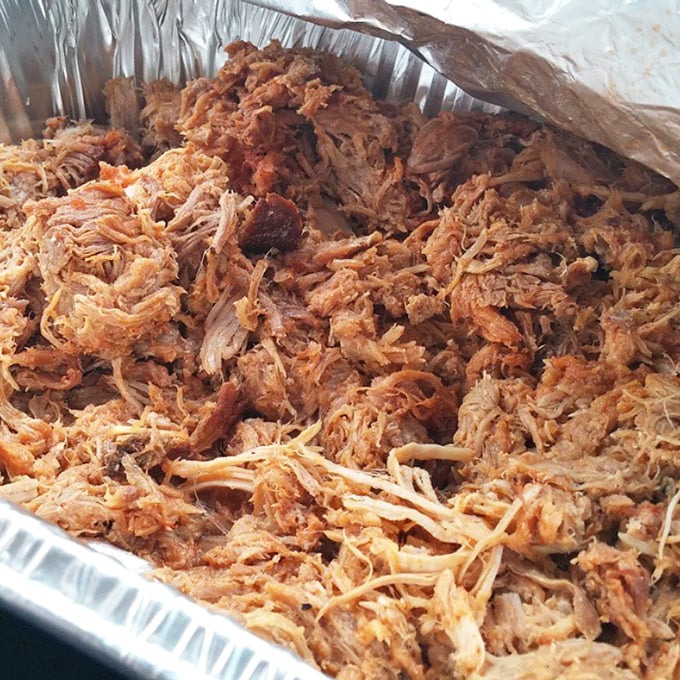 This tray of pulled pork is Arkansas poetry – each strand telling a story of smoke, time, and tradition that began long before Instagram food pics existed.