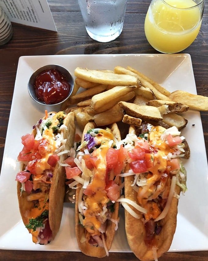 These aren't just tacos—they're edible art. Crispy shells cradle fresh ahi tuna topped with a confetti of cheese, tomato, and slaw.