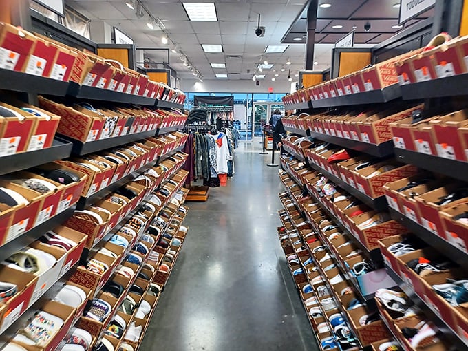 This shoe aisle stretches into infinity like a sneakerhead's fever dream, organized chaos at its most beautiful.