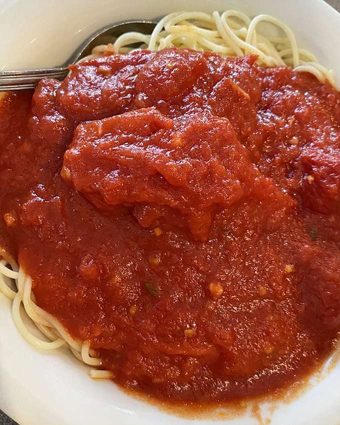 Spaghetti with red sauce—simple as a three-chord rock song but just as powerful. This marinara has clearly been simmering since breakfast, developing flavors your jar at home can only dream about.