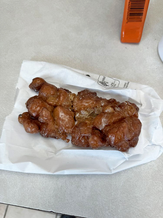 This apple fritter isn't just a donut—it's a commitment, a relationship, a delicious mountain of glazed apple-cinnamon goodness.