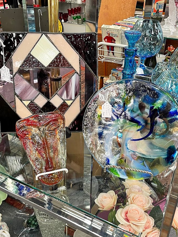 Stained glass meets art glass in this dazzling display. That blue swirled plate looks like it captured an ocean wave mid-crash.