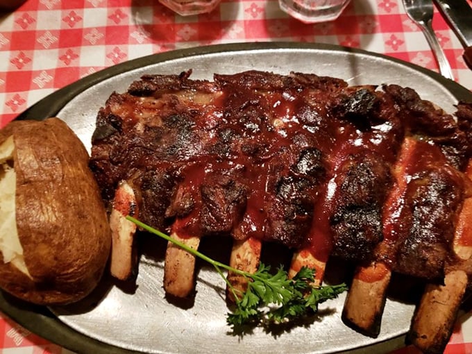 These BBQ beef ribs aren't just falling off the bone—they're practically jumping onto your fork, begging to be devoured alongside that picture-perfect baked potato.