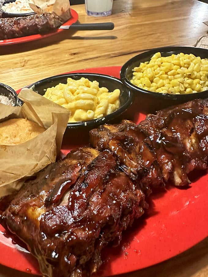 Baby back ribs glistening with sauce, flanked by mac and cheese and corn—a trio so perfect they could headline at the Grand Ole Opry.