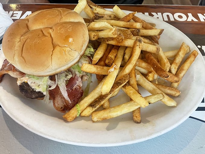 This isn't just a burger—it's architecture. The perfect stack of beef, bacon, and fresh toppings with fries so golden they deserve their own Instagram account.