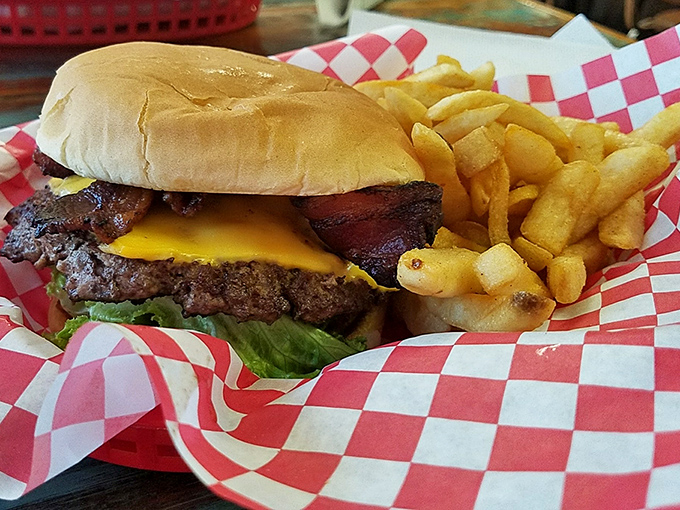 The bacon cheeseburger arrives stacked so high it requires an engineering degree to figure out the proper eating angle.