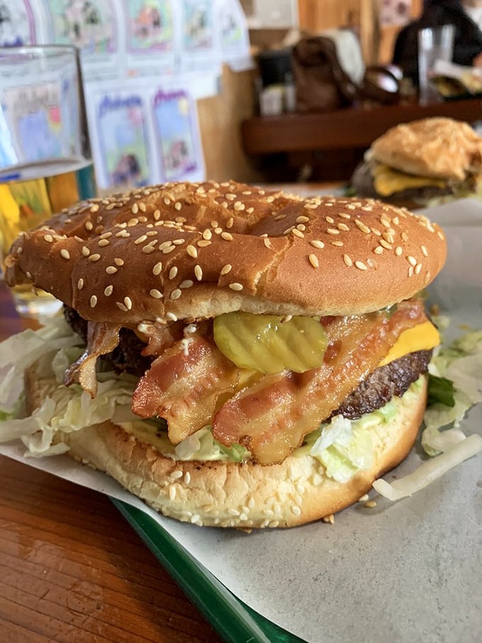 The bacon cheeseburger arrives like a beautiful, messy promise. When bacon cascades down the sides, you know you're in for something special.