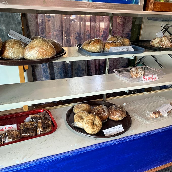 Fresh-baked treasures await behind glass, each promising to transport you to the old country. These golden-brown loaves aren't just bread—they're edible history.
