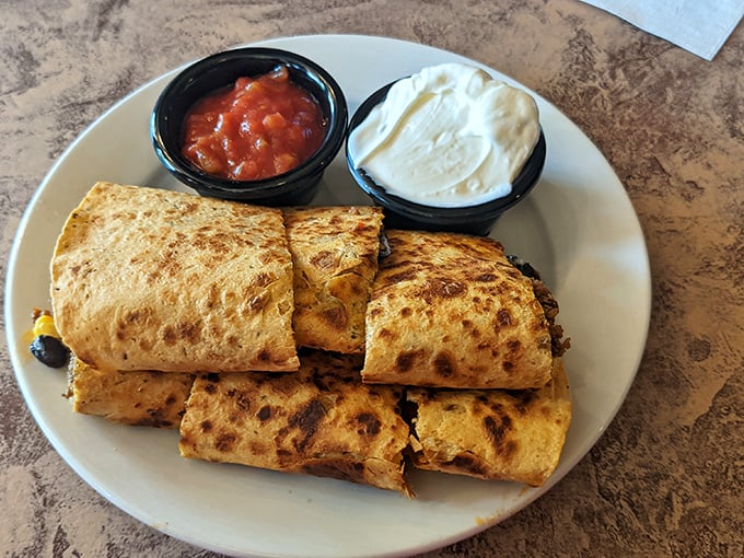 Quesadillas done right—golden-brown tortillas with just enough char, served with the holy trinity of toppings: salsa, sour cream, and guacamole.