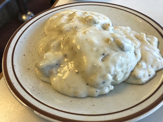 The biscuits and gravy—where pepper-flecked cream sauce cascades over fluffy biscuits like a comfort food waterfall. Worth every calorie and food coma risk.