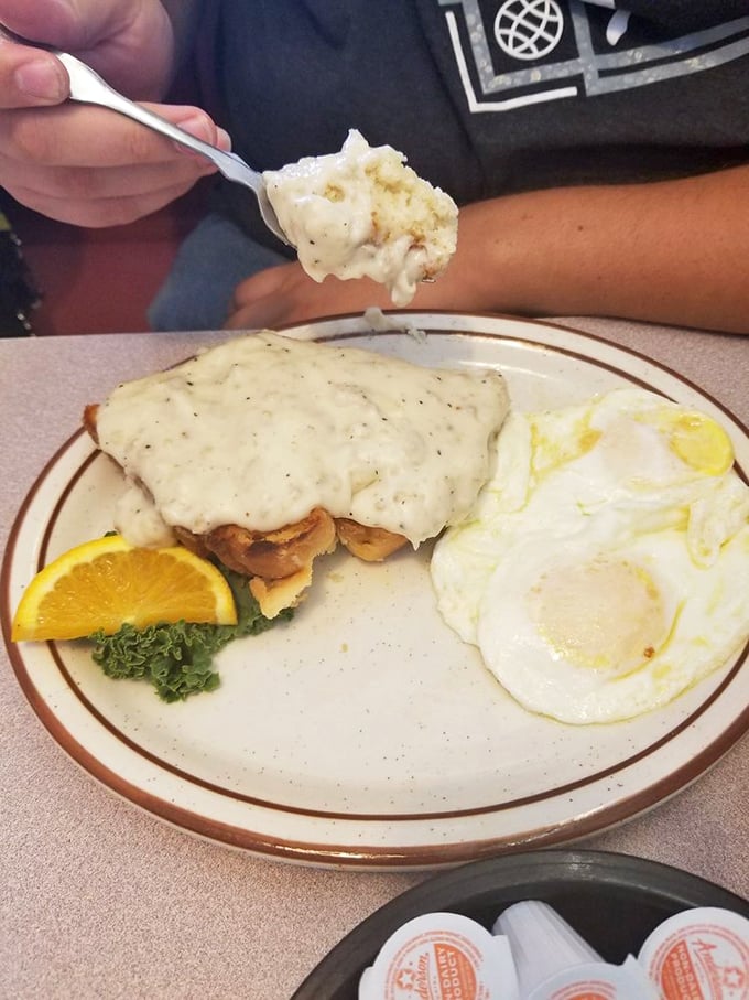 Biscuits smothered in country gravy with eggs sunny-side up—the breakfast equivalent of hitting the jackpot without placing a bet.