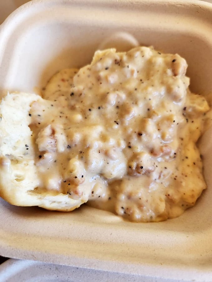 Comfort in a bowl: creamy, pepper-flecked gravy smothering a freshly baked biscuit. The kind of breakfast that hugs you from the inside out.