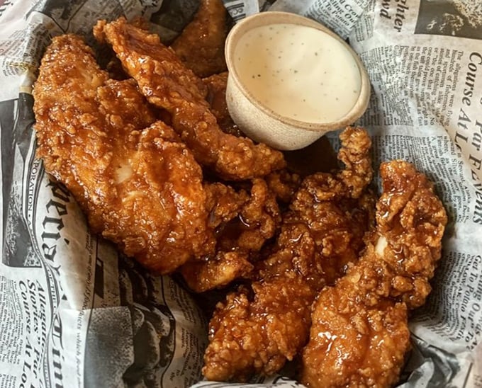 These aren't just wings; they're crispy vessels of happiness served on newspaper – because good food should be headline-worthy.