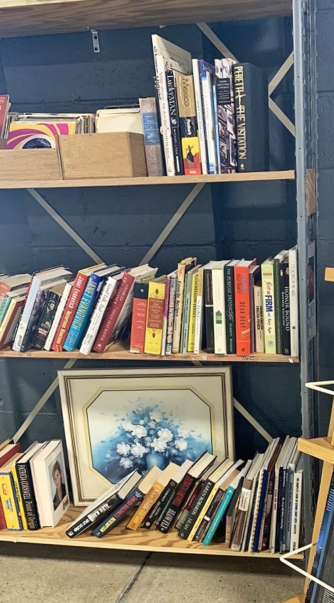 Books stacked alongside vintage art prove one person's spring cleaning becomes another's literary and decorative jackpot every single day.
